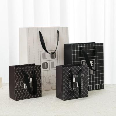 China Custom Pink Recyclable Coated Paper Clothing Bags with Ribbon Handle 30x40cm for sale