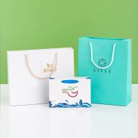 China Custom Kraft Paper Bags with Smooth Lamination and Three-Strand Rope Handles for Retail Stores for sale