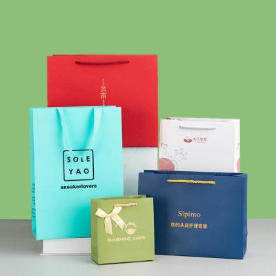 China Custom Paper Bags for Clothing Store Offset Printing Surface Handling Toowin 300gsm Kraft Paper for sale