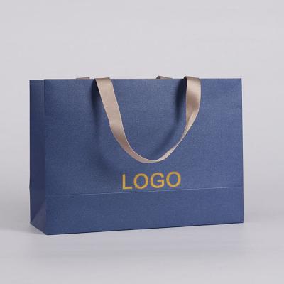 China Custom Kraft Paper Shopping Bag with Blue Rivets and Handle for Retail Gifts for sale