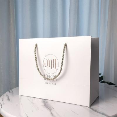 China Custom Printed Hot Foil Stamping Logo Handheld Paper Bag for Clothing Promotion 300gsm for sale