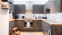 China Good Praise Degree Glossy Wood Kitchen Pantry Cabinet with E1 Particleboard Material for sale