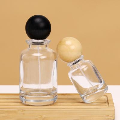 China Custom Clear Glass Perfume Bottles 30ml 50ml 100ml with Ball Cap for sale