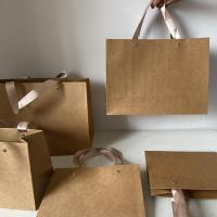 China Custom Kraft Paper Tote Bag 24x10x17cm & 35x13x26cm Sizes with Foil Stamping and UV Coating Options for sale
