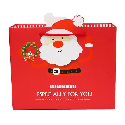 China Custom Christmas Cartoon Paper Gift Bags 24x10x32cm Kraft Tote Bags for sale