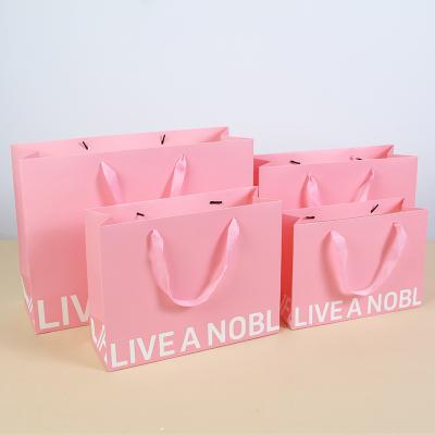 China Custom Thickened Kraft Paper Gift Bags 28x20x10cm Clothing Store Tote Bags with Logo for sale