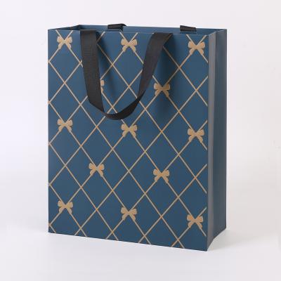 China Custom Kraft Paper Bags 25x12x32cm for Garment Cosmetic Gift Packaging for sale