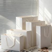 China Custom White Cardboard Tote Bags 13x19x6cm Gift Bags for Clothing Stores for sale