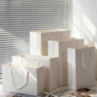 China Custom White Cardboard Tote Bags 13x19x6cm Gift Bags for Clothing Stores for sale