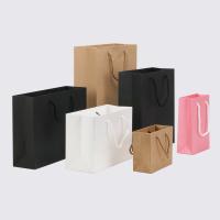 China Custom Logo Paper Gift Bags with Twisted Rope Handles for Shopping Clothing Packaging 250gsm for sale