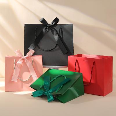 China Luxury Solid Color Kraft Paper Gift Bags with Ribbon Handles Custom Size Bulk for Retail Packaging for sale