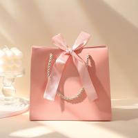 China Luxury Solid Color Kraft Paper Gift Bags with Ribbon Handles Custom Size Bulk for Retail Packaging for sale