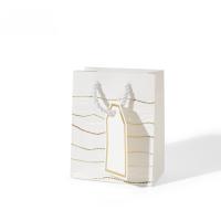 China Custom Embossed Paper Gift Bags with Rope Handles Pastel Gold Wave Design for Weddings Birthdays Shopping for sale