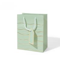 China Custom Embossed Paper Gift Bags with Rope Handles Pastel Gold Wave Design for Weddings Birthdays Shopping for sale