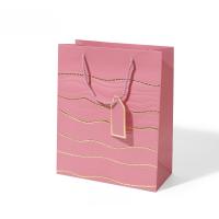 China Custom Embossed Paper Gift Bags with Rope Handles Pastel Gold Wave Design for Weddings Birthdays Shopping for sale