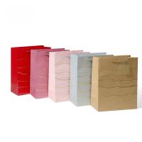 China Custom Embossed Paper Gift Bags with Rope Handles Pastel Gold Wave Design for Weddings Birthdays Shopping for sale