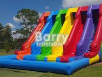 China 4 Lane Big Colorful Rainbow Inflatable Water Slides With Pool for sale