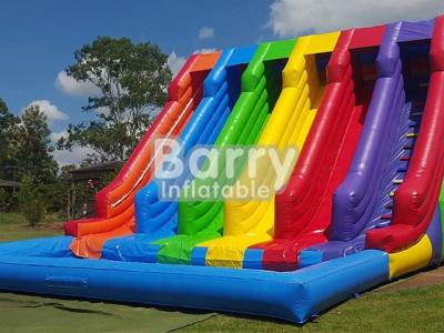China 4 Lane Big Colorful Rainbow Inflatable Water Slides With Pool for sale