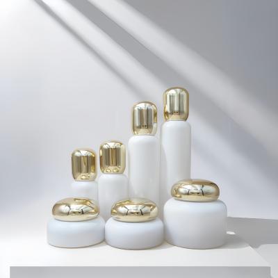 China Cosmetic Packaging Glass Lotion Bottle Cream Jar Skin Care Containers With Gold Round Cap for sale