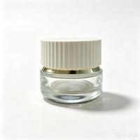 China Luxury Glass Jar 30g and 50g with Vertical Ribbed White Cap Gold Decorative Ring for Face Cream Skincare Container for sale