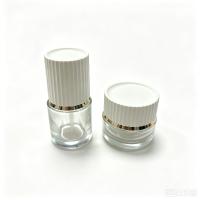 China Luxury Glass Jar 30g and 50g with Vertical Ribbed White Cap Gold Decorative Ring for Face Cream Skincare Container for sale