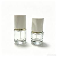 China Empty Clear Glass Pump Bottle 30ml and 50ml Cosmetic Serum Lotion Container Ribbed White Cap Gold Press Pump Skincare Packaging for sale