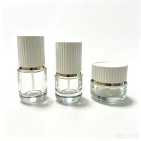 China Empty Clear Glass Pump Bottle 30ml and 50ml Cosmetic Serum Lotion Container Ribbed White Cap Gold Press Pump Skincare Packaging for sale