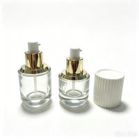 China Empty Clear Glass Pump Bottle 30ml and 50ml Cosmetic Serum Lotion Container Ribbed White Cap Gold Press Pump Skincare Packaging for sale