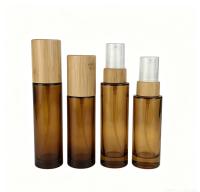 China 30ml 50ml customed Color Glass Bottle Press Pump Type Bamboo Lid  for Cosmetics for sale