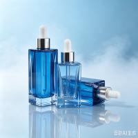 China Blue Transparent Glass Dropper Bottle, Thick Base Square Cosmetic Serum Oil Packaging Bottle with White Rubber Dropper for sale