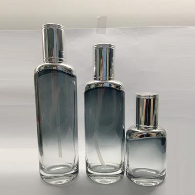 China 40ml 100ml 120ml Glass Lotion Bottle Set With Metallic Silver Shoulder for sale