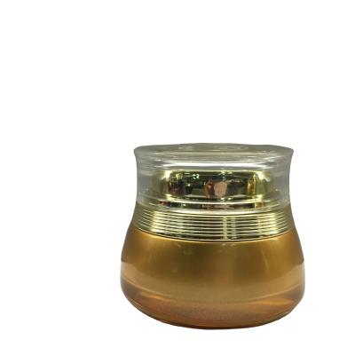 China Luxury Round Face Moisturizer Glass Jar 50g MSDS Cosmetic Jars With Gold Lids for sale