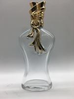 China Embossed Logo Empty Perfume Glass Bottles Body Shape Unique Cap 100ml for sale
