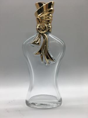 China Embossed Logo Empty Perfume Glass Bottles Body Shape Unique Cap 100ml for sale