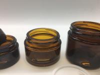 China Transparent Cosmetic Refill Amber Glass Jar Straight Round Shape With Plastic Black Lid for sale