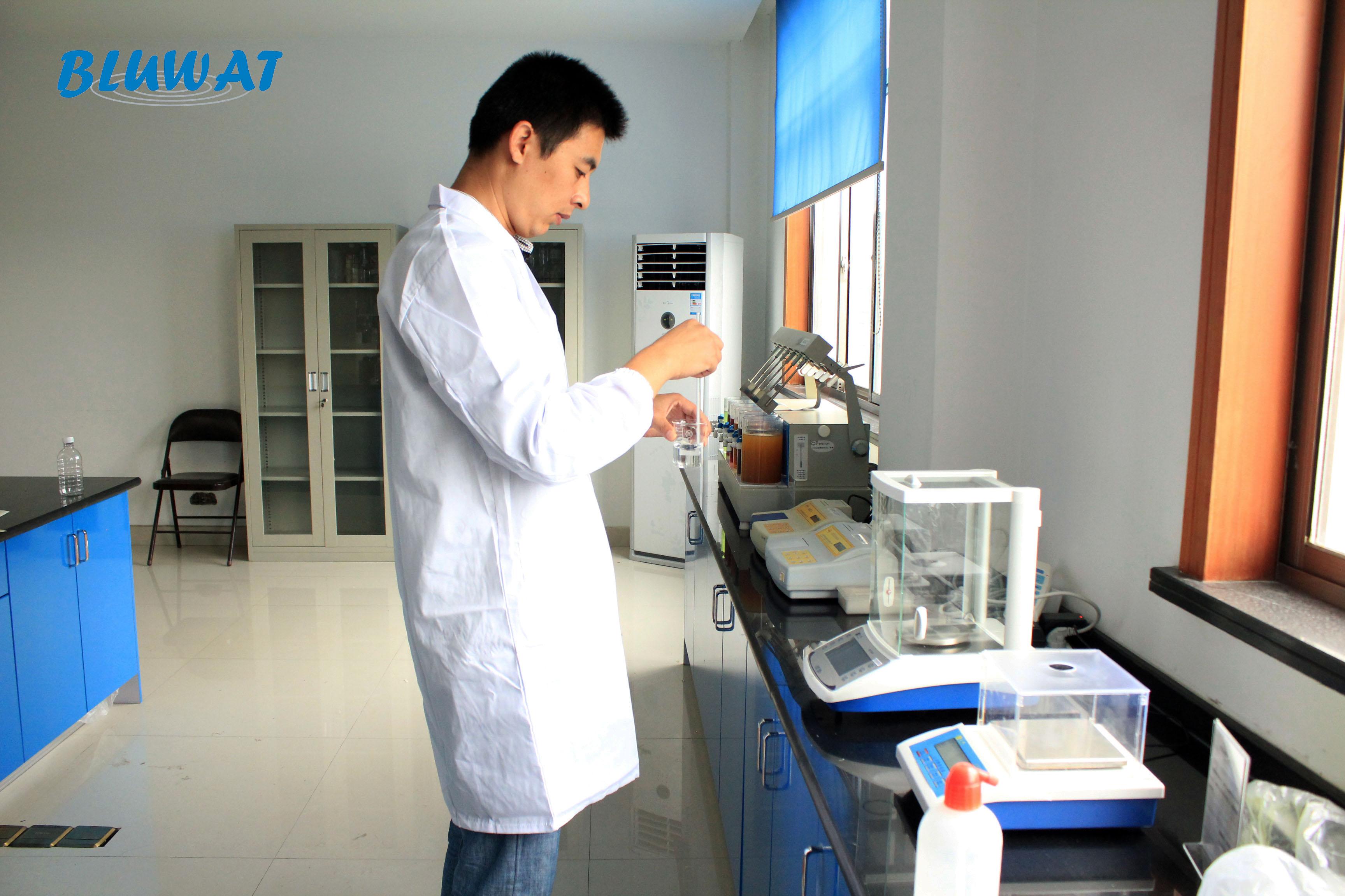 Bluwat laboratory technician testing BWD-01 Water Decoloring Agent quality before shipment