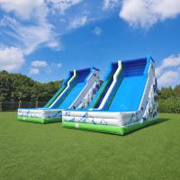 China Commercial K2 Double Lane Inflatable Slide with Mountain Graphics High Side Walls and Safety Landing Areas for Parks Events and Rentals for sale