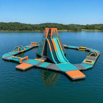 China Commercial Summit Adventure Floating Inflatable Water Park with Dual Racing Slides Climbing Tower Balance Obstacles and Modular Walkways for sale