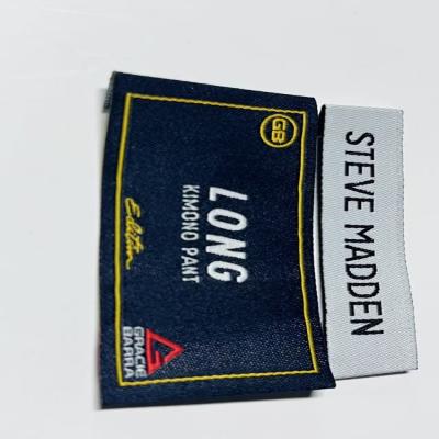 China Ultrasonic Cut Embroidered Woven Clothing Labels Garment Tags Custom for sale