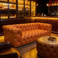 China Modern Luxury Orange Leather Chesterfield Sofa Full Tufted Low Profile 3 Seater Hotel Upholstered for Creative Culb Bar for sale