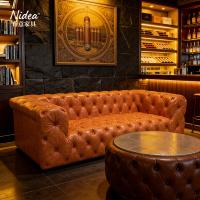 China Modern Luxury Orange Leather Chesterfield Sofa Full Tufted Low Profile 3 Seater Hotel Upholstered for Creative Culb Bar for sale
