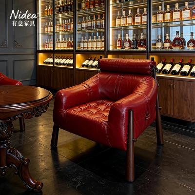 China Modern Luxury Red Leather Accent Chair Designer Tufted Armchair with Cylindrical Headrest & Buckle Details Living Room Club Bar for sale