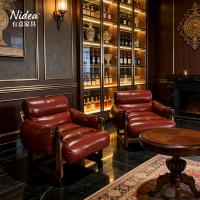 China Modern Luxury Wine Red Waxed Leather Lounge Chair Designer Puffy Segmented Solid Wood Armchair for Living Room Club Bar for sale
