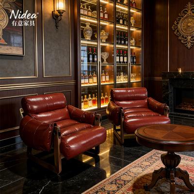 China Modern Luxury Wine Red Waxed Leather Lounge Chair Designer Puffy Segmented Solid Wood Armchair for Living Room Club Bar for sale