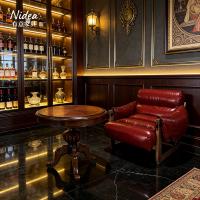 China Modern Luxury Wine Red Waxed Leather Lounge Chair Designer Puffy Segmented Solid Wood Armchair for Living Room Club Bar for sale