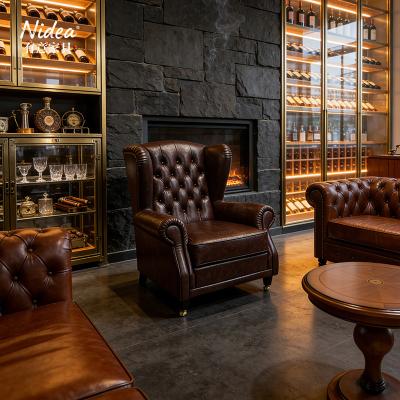 China Luxury Vintage Wine Red Leather Chesterfield Wingback Armchair Tufted Design Ergonomic Durable Build Brass Casters Club Bar for sale