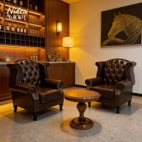 China Luxury Vintage Brown Leather Wingback Chesterfield Chair Classic Deep Button Tufted Armchair Nailhead Trim Living Room Office for sale