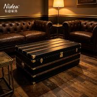 China Luxury Vintage Black Leather Trunk Coffee Table with Wood Slats Gold Hardware Storage Chest and Side Drawers for Home Bar for sale