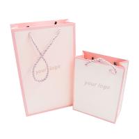 China Carry Custom Paper Shopping Bags 250g Embossed Promotional With Matched PP Rope Handle for sale