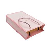 China Carry Custom Paper Shopping Bags 250g Embossed Promotional With Matched PP Rope Handle for sale